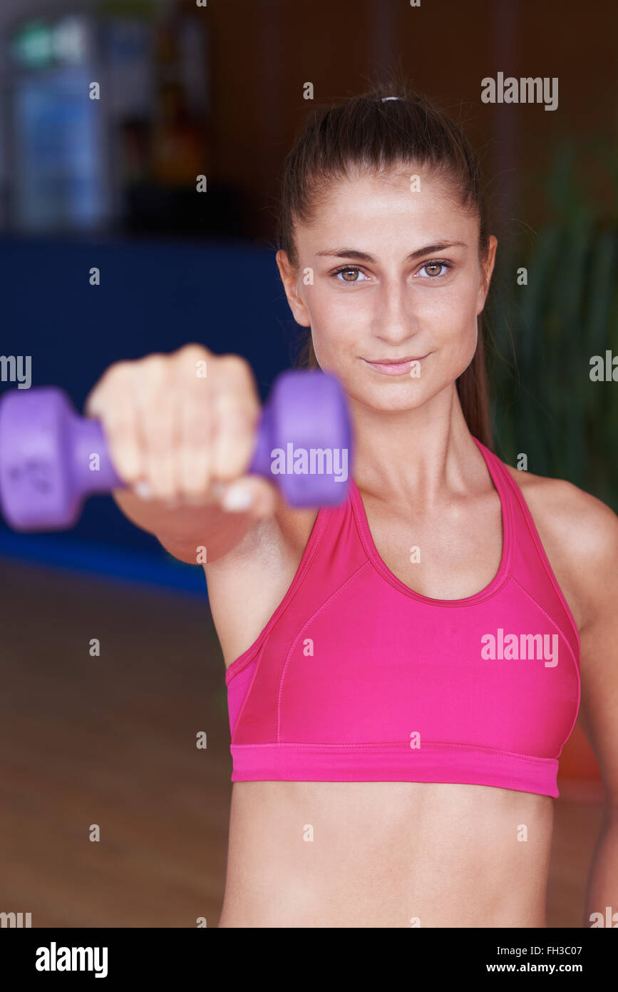 lifting some weights and working on her biceps in a gym Stock Photo - Alamy