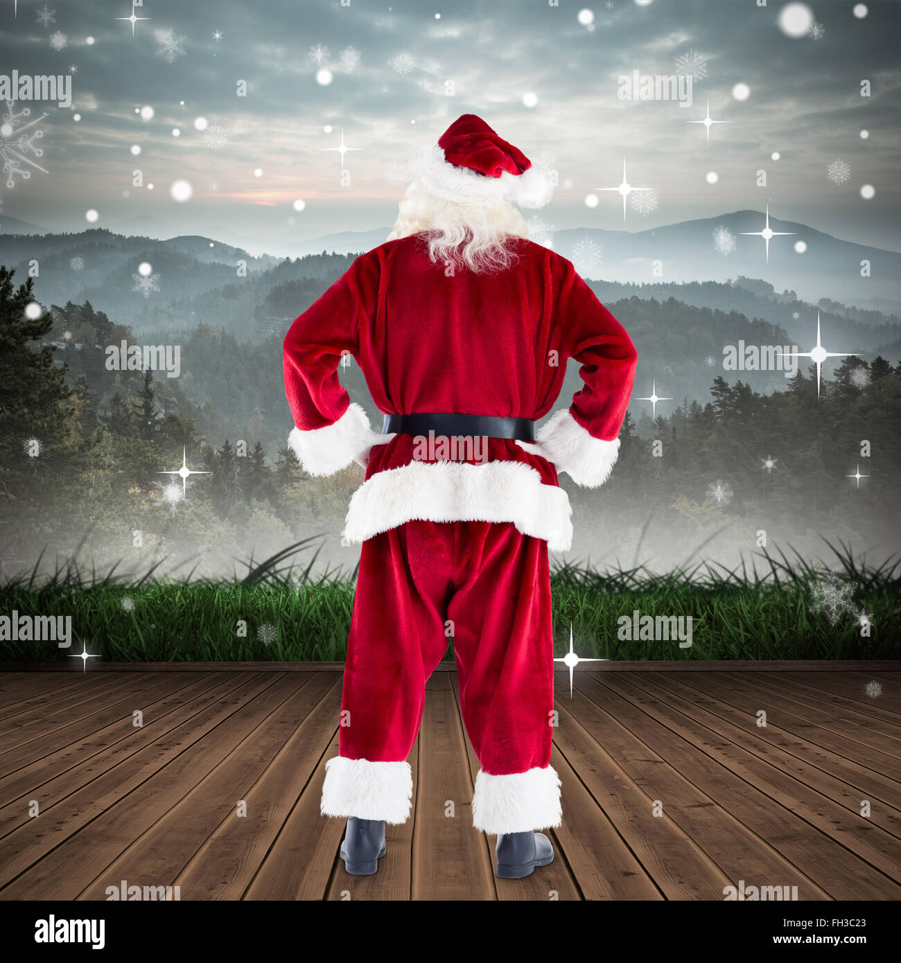 Composite image of santa standing with hands on hips Stock Photo - Alamy