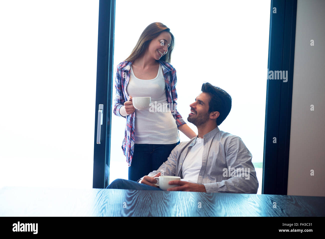 relaxet young couple drink first morning coffee Stock Photo - Alamy