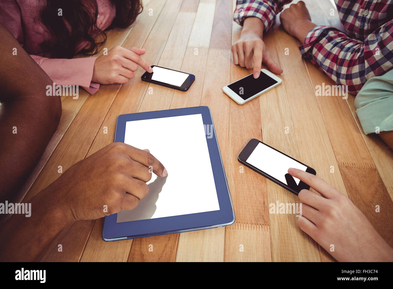Young creative team using phones and tablet Stock Photo - Alamy