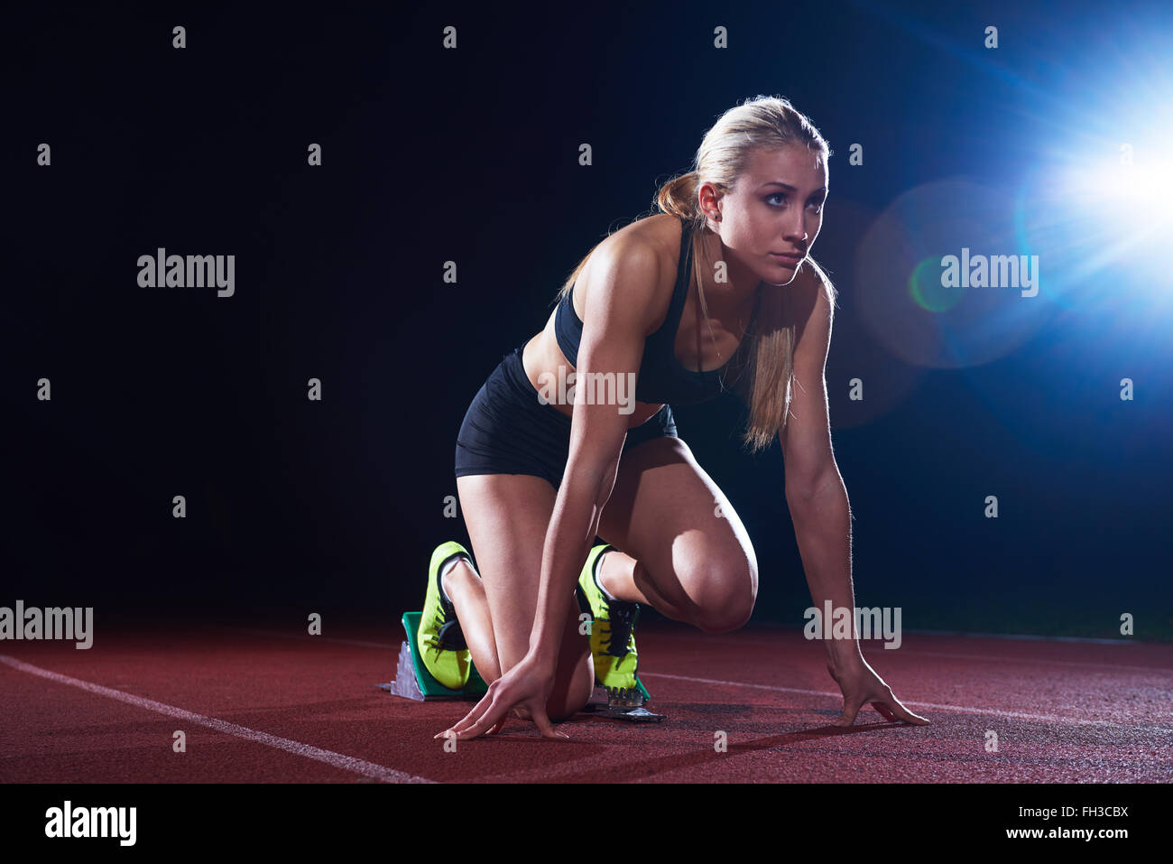 Female sprinter leaving starting blocks hi-res stock photography and ...