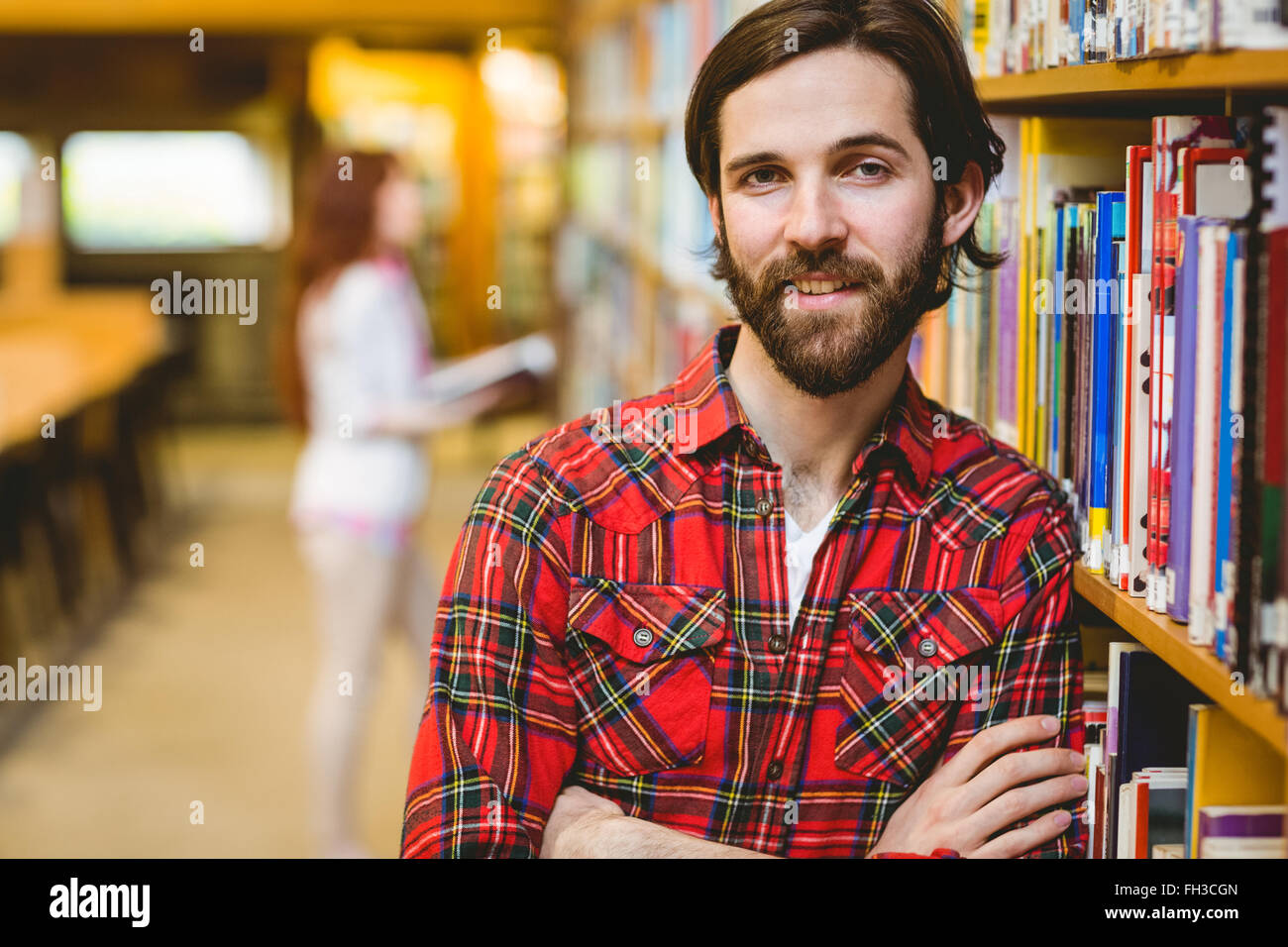 Smiling student in the library Stock Photo - Alamy
