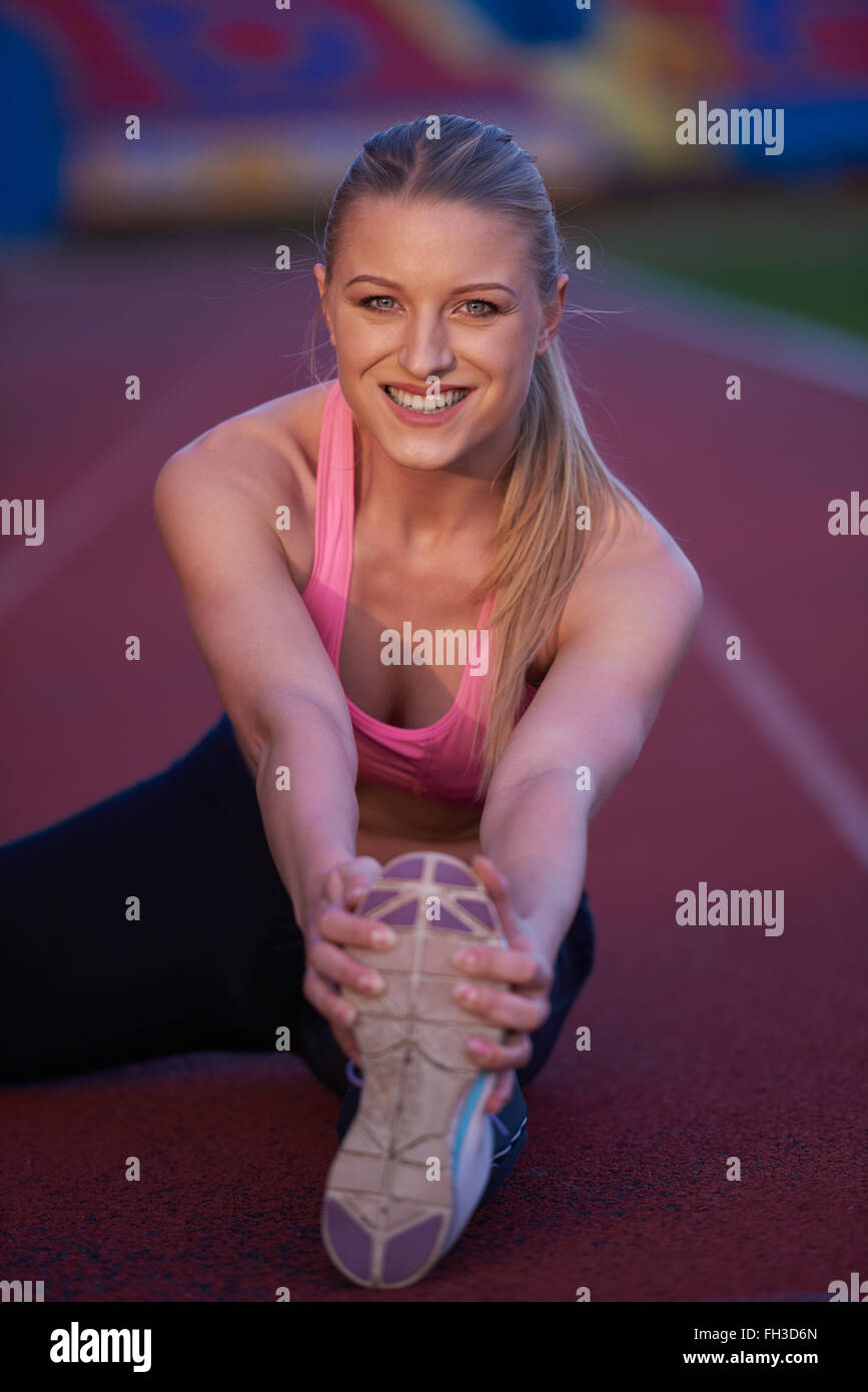 sporty woman on athletic race track Stock Photo - Alamy