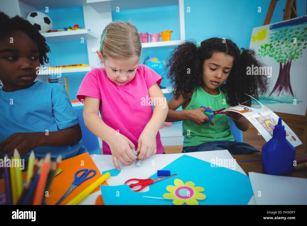 Happy kids doing arts and crafts together Stock Photo - Alamy