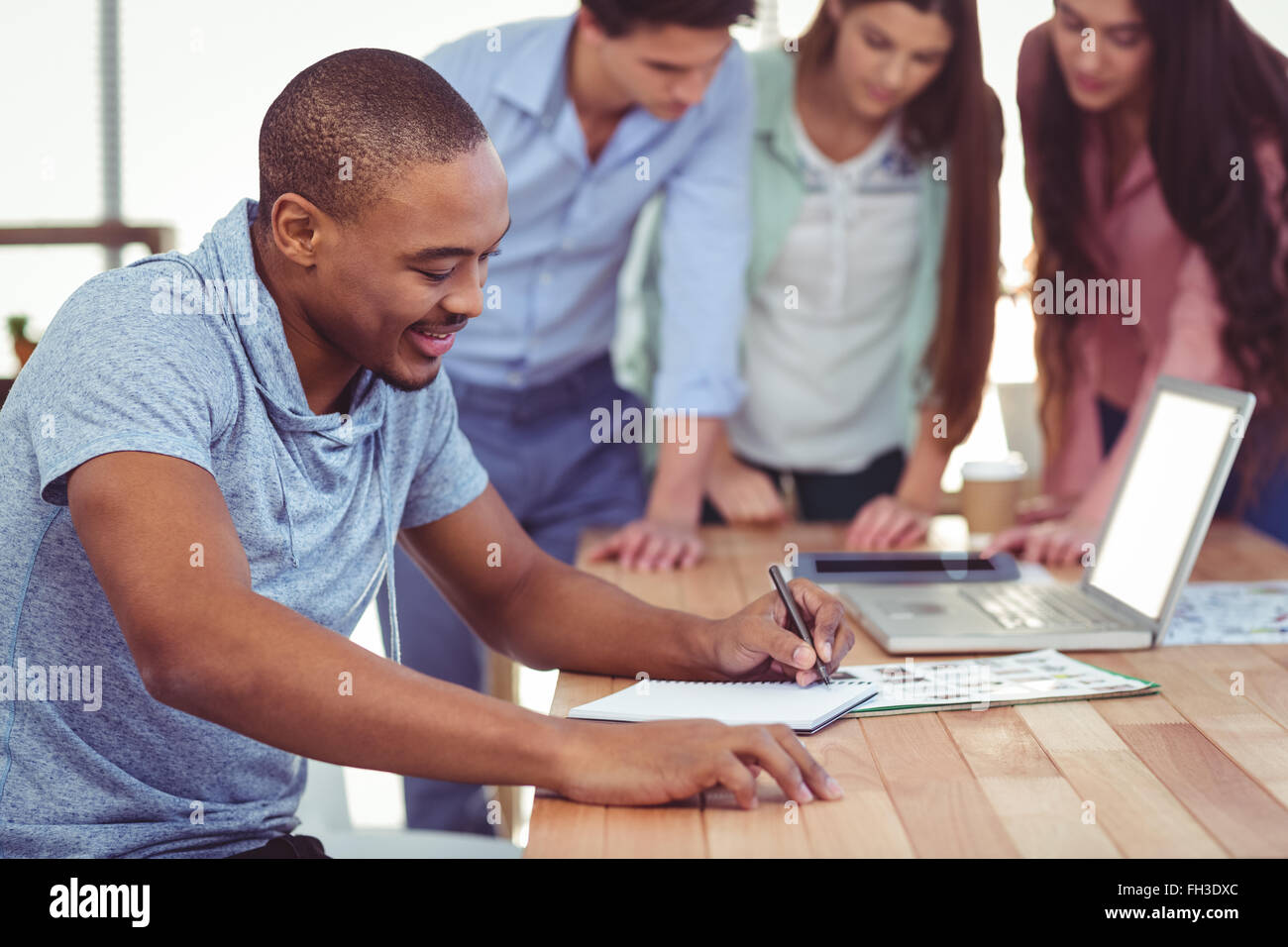 Young creative team working together Stock Photo - Alamy