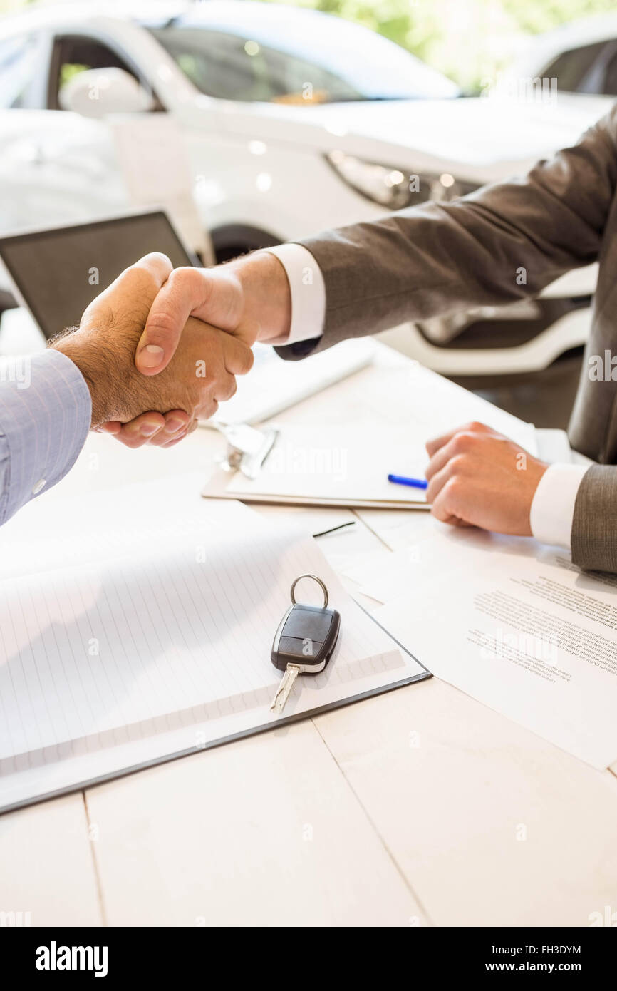 Salesman shaking a customer hand Stock Photo - Alamy