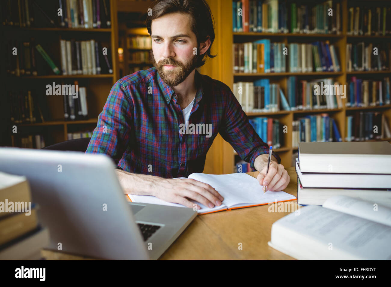 Thoughtful man laptop in library hi-res stock photography and images ...