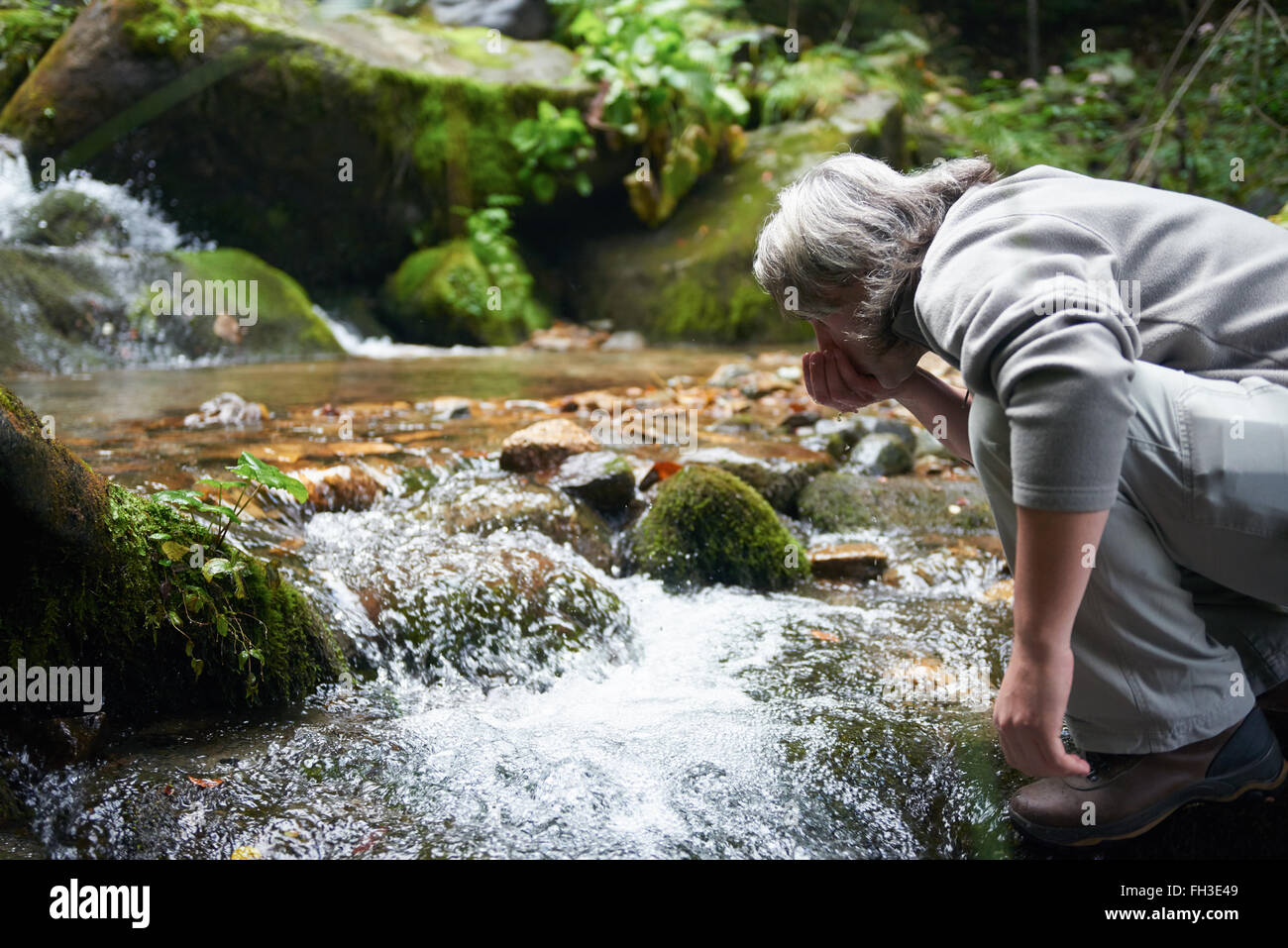 man drinking fresh water from spring Stock Photo - Alamy