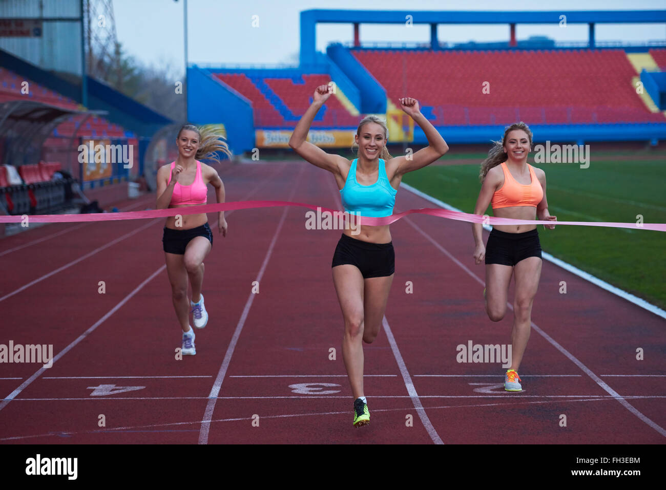 Female Runners Finishing Race Together Stock Photo - Alamy
