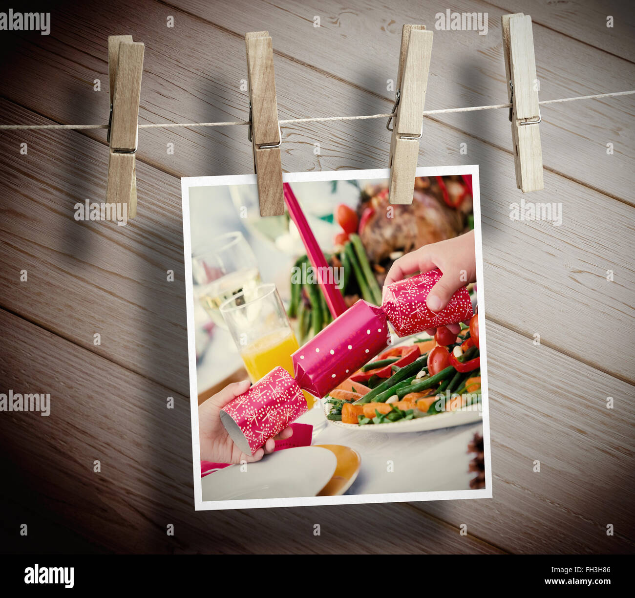 Composite image of photo hanging from line Stock Photo - Alamy
