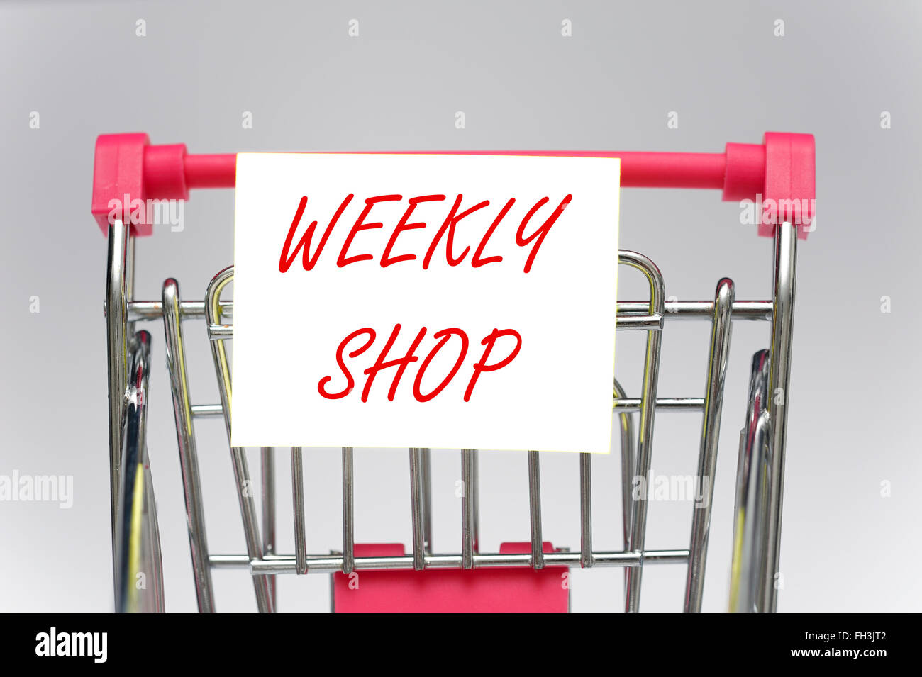 A miniature shopping trolley with a weekly shop sign on Stock Photo - Alamy