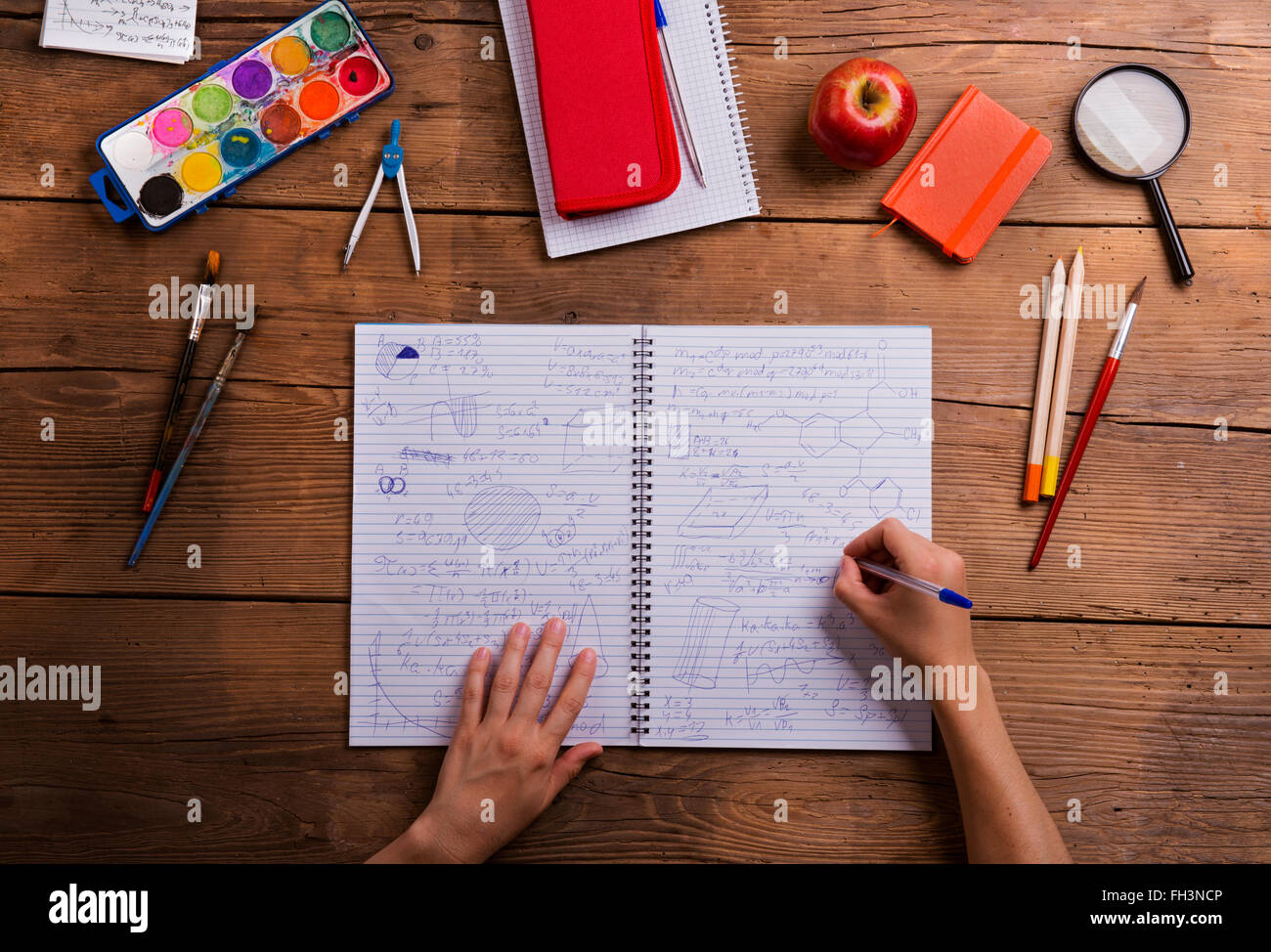 Hands of man with math notebook. Various school supplies Stock Photo ...