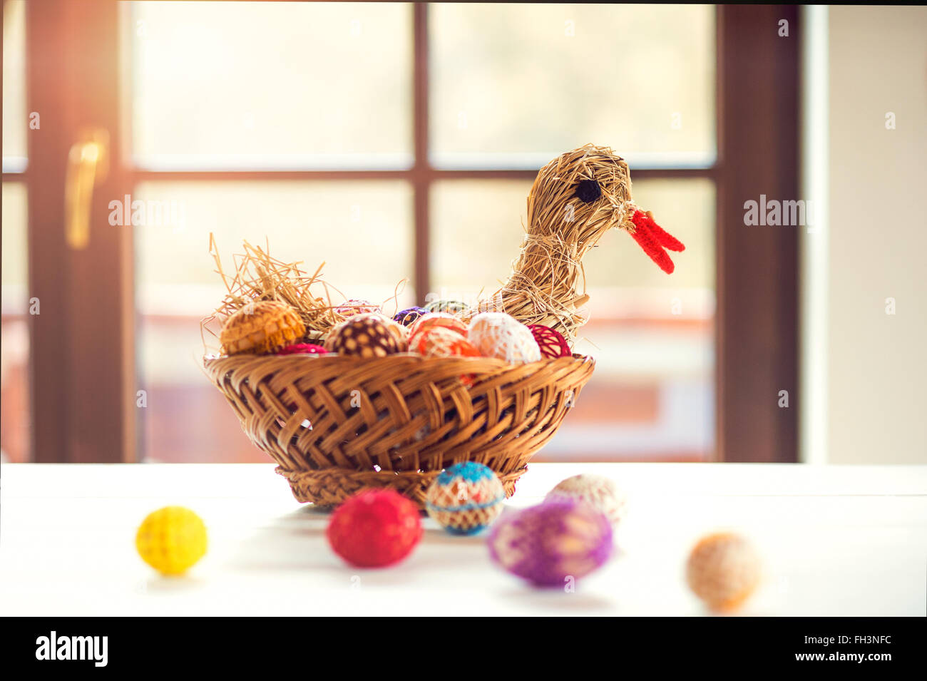 Crocheted Easter eggs and straw hen in wicker basket Stock Photo - Alamy