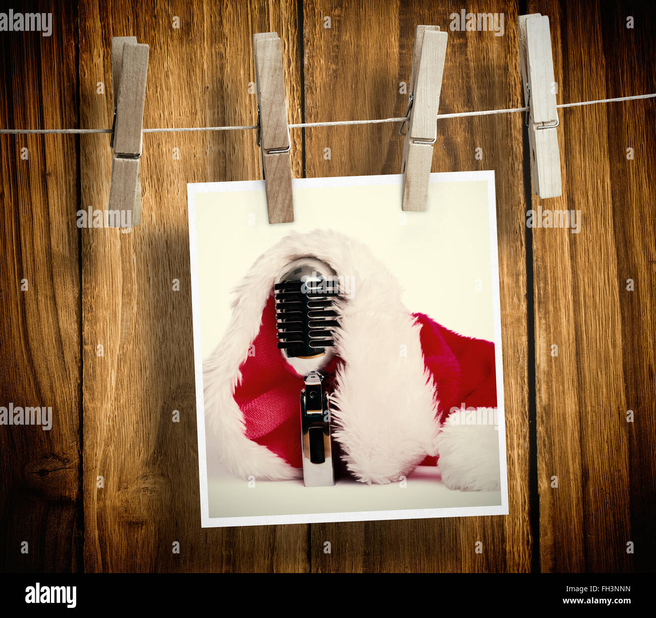 Composite image of photo hanging from line Stock Photo - Alamy