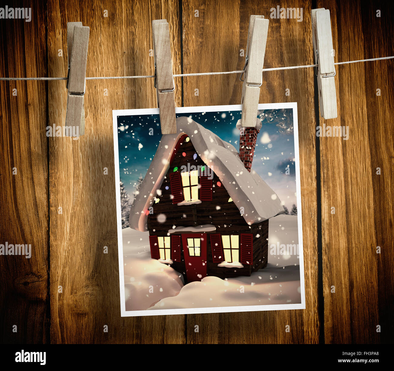 Composite image of photo hanging from line Stock Photo - Alamy