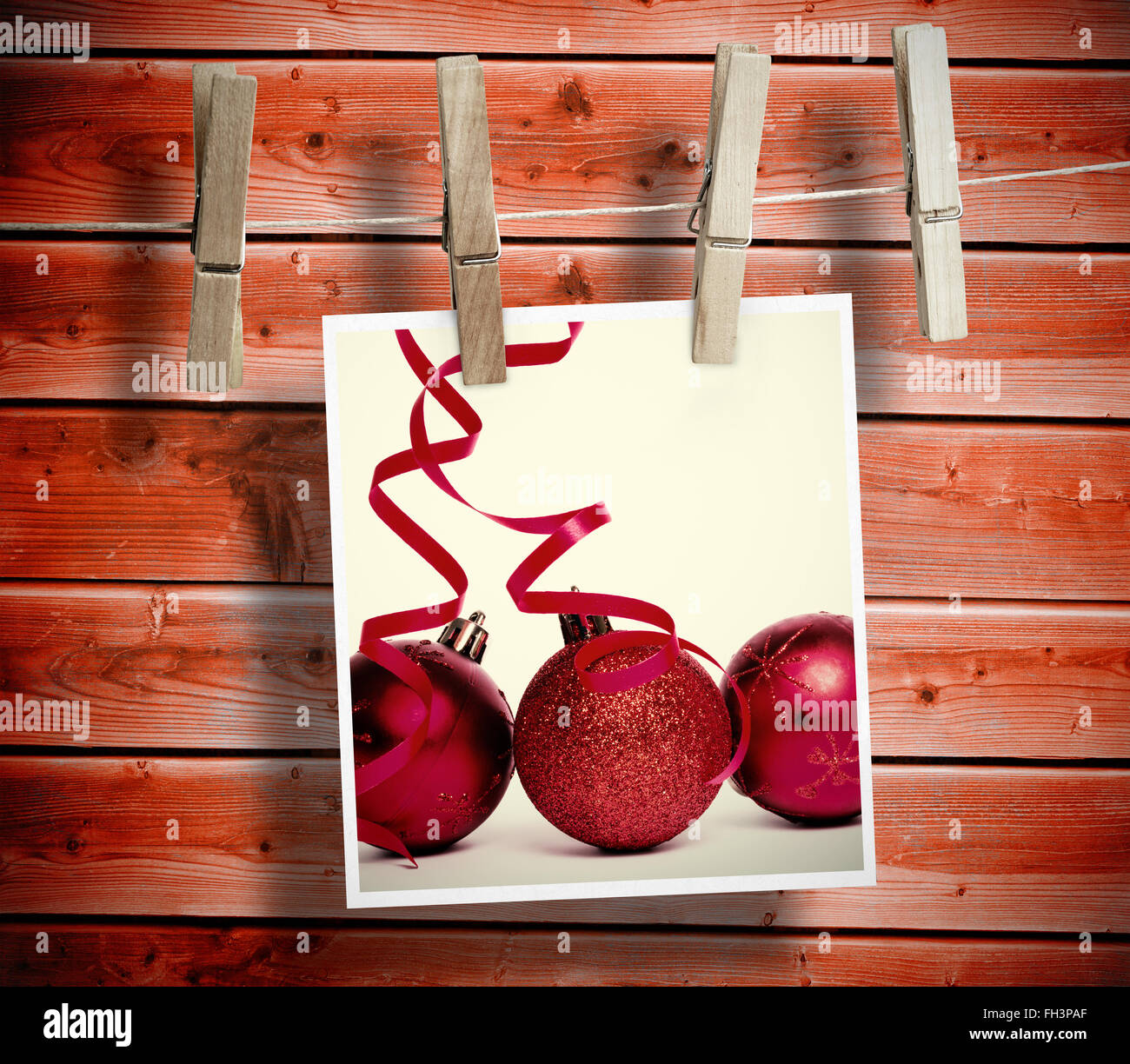 Composite image of photo hanging from line Stock Photo - Alamy