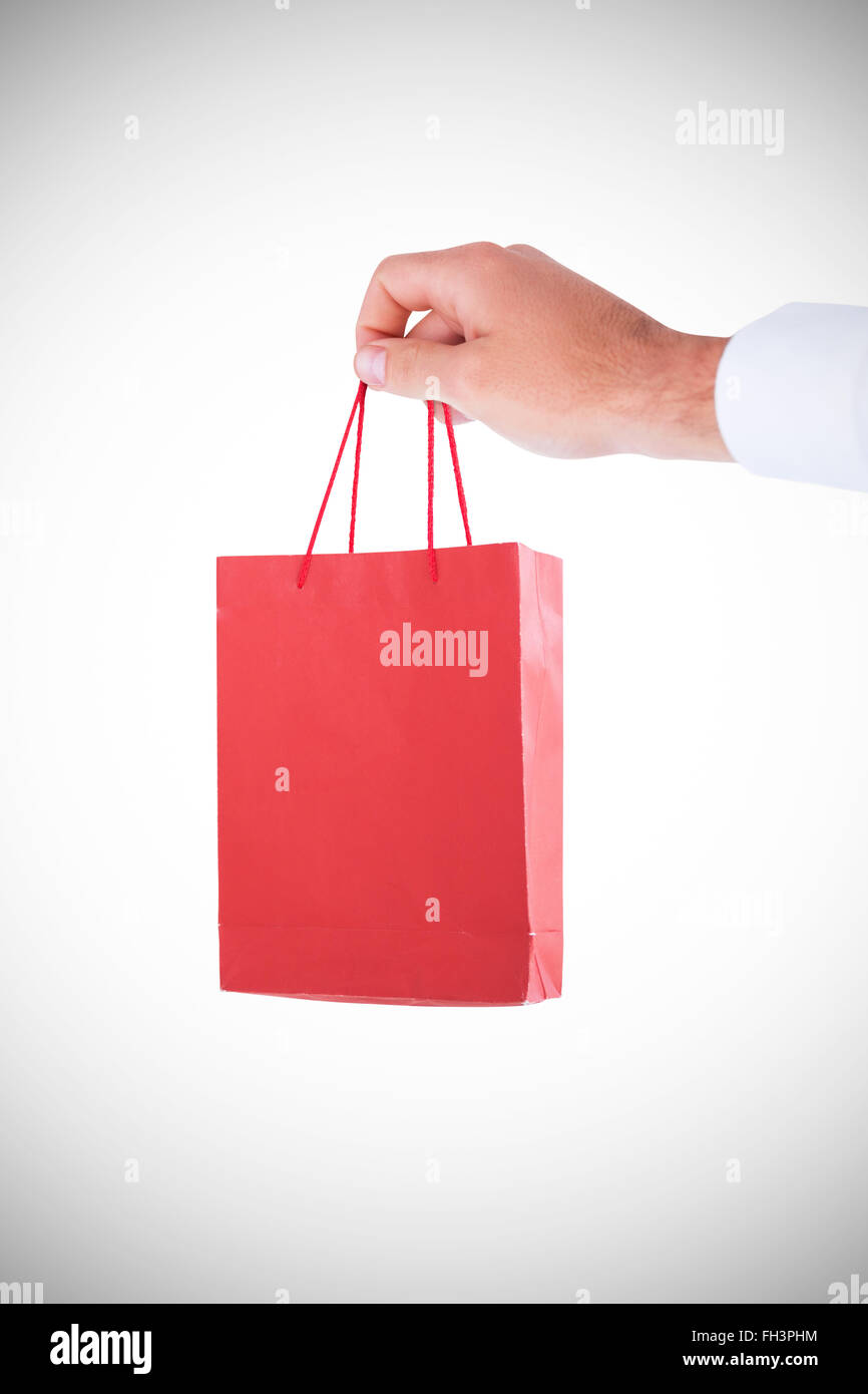 A Hand holding a gift bag Stock Photo - Alamy