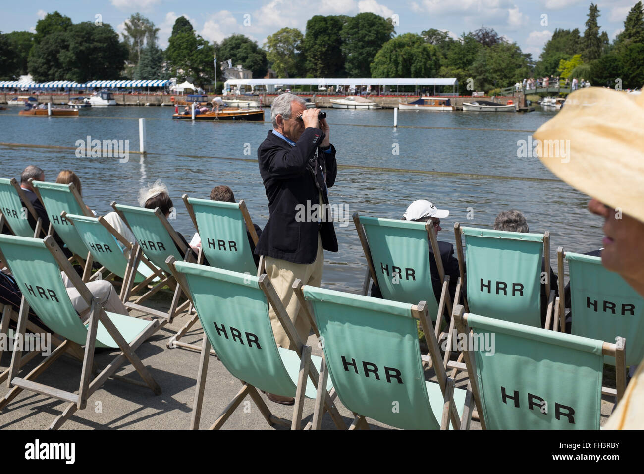 A spectator at Henley Royal Regatta surveys the course Stock Photo - Alamy