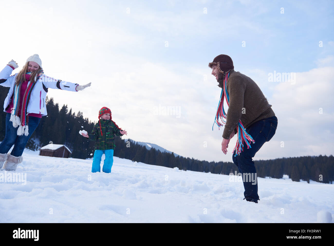 happy family playing together in snow at winter Stock Photo - Alamy