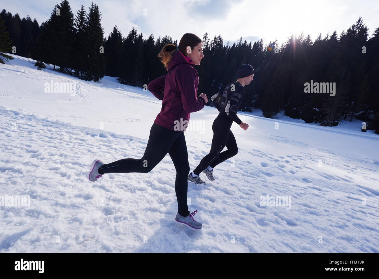 couple jogging outside on snow Stock Photo - Alamy