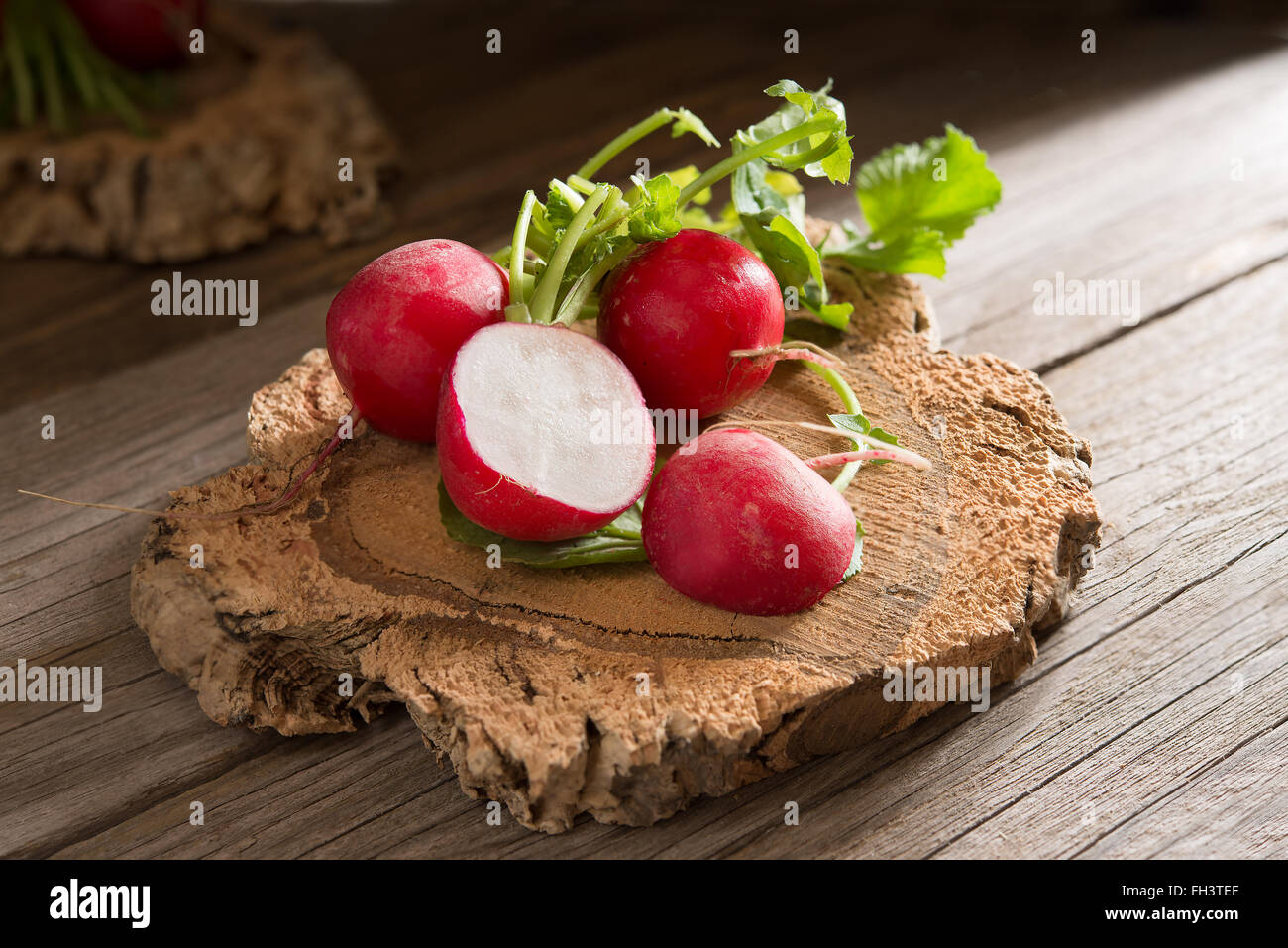 fresh sliced radish on wooden cork Stock Photo - Alamy