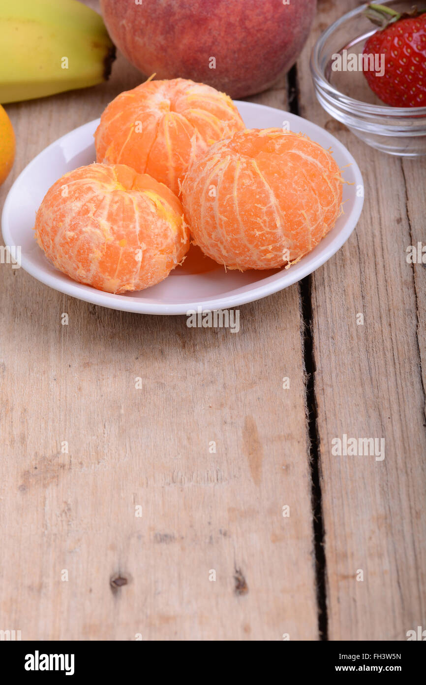 Fresh colorful fruits composition mandarin, strawberry, peach, bananas ...