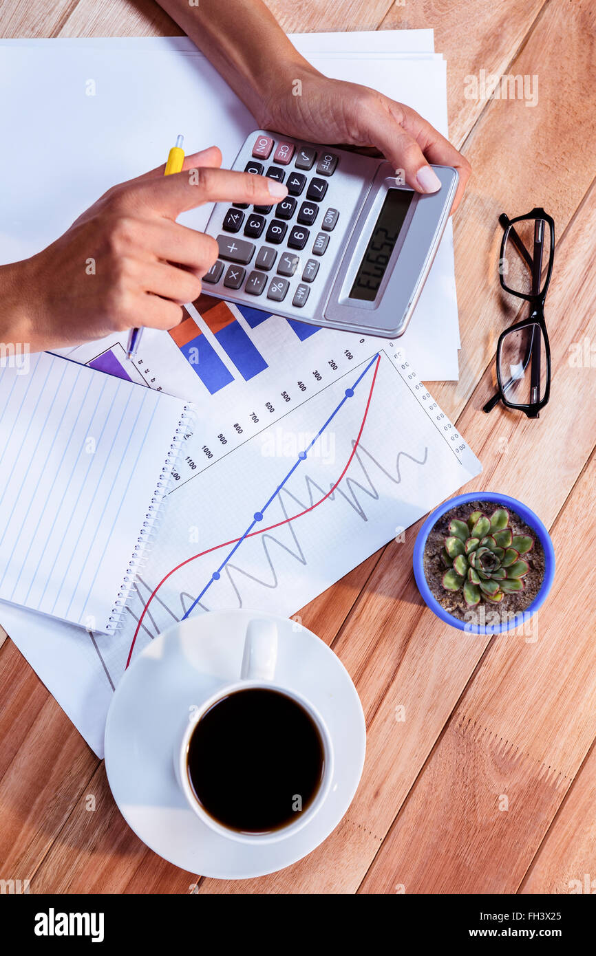 Part of hands typing on calculator Stock Photo - Alamy