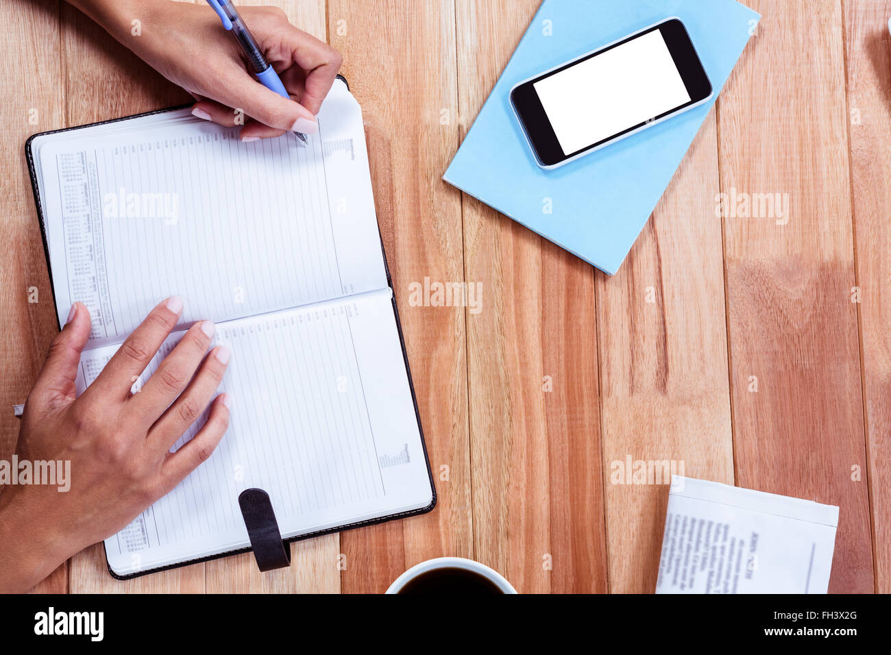 Overhead of feminine hands writing Stock Photo - Alamy