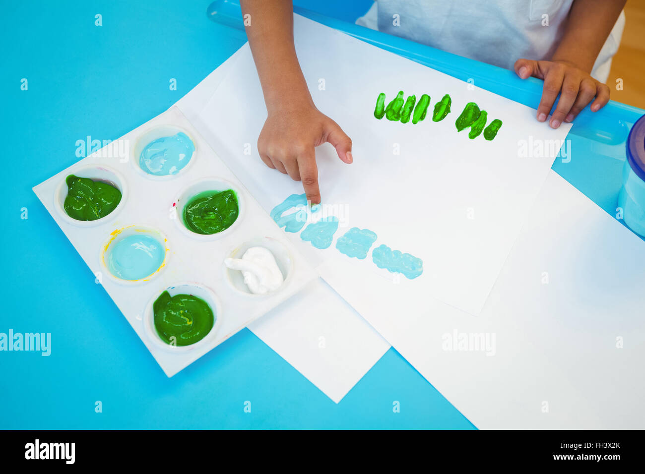 Girl painting with finger colours hi-res stock photography and images ...