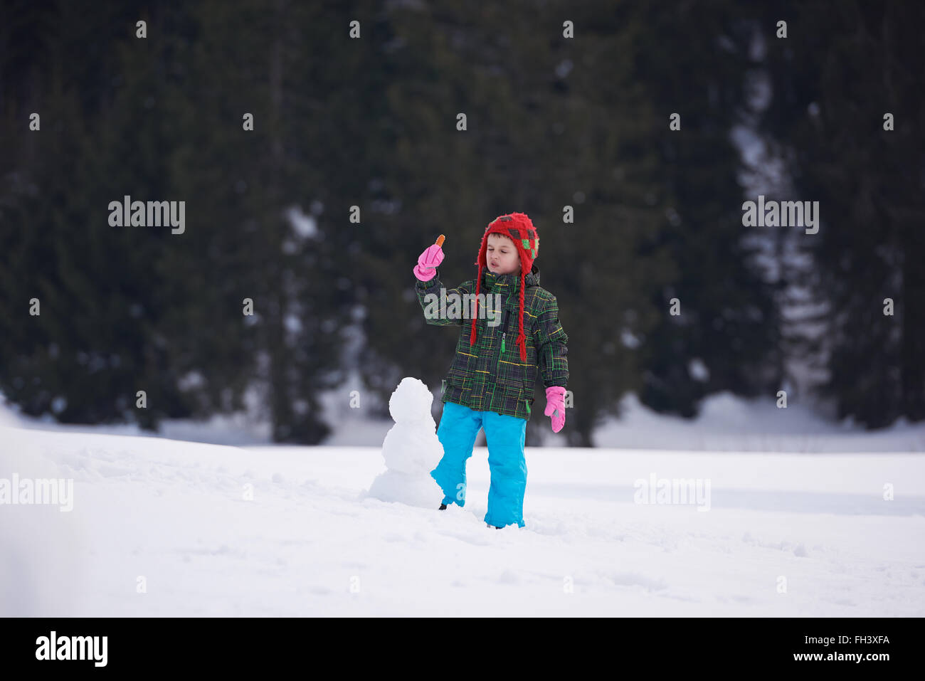 boy making snowman Stock Photo - Alamy