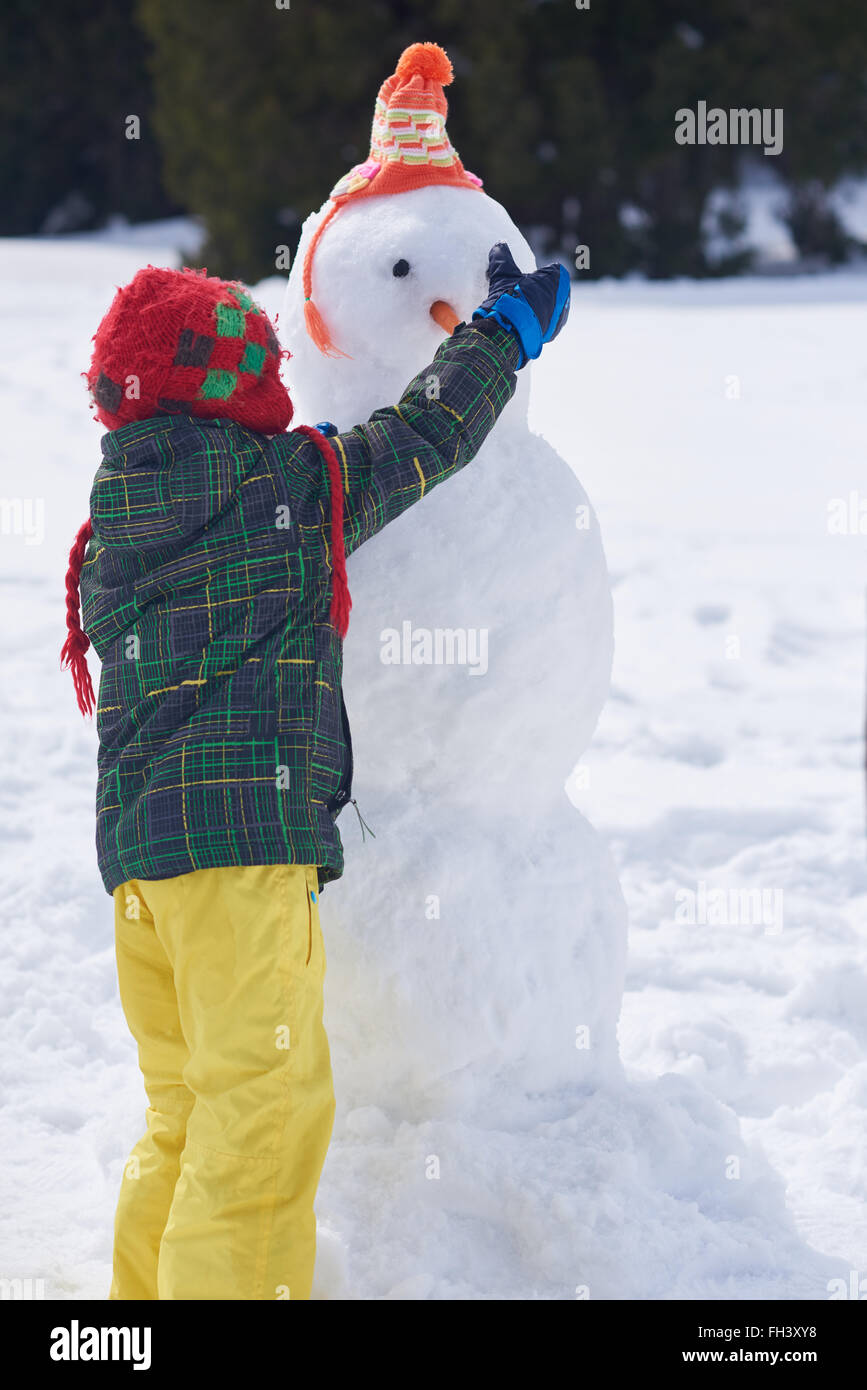 boy making snowman Stock Photo - Alamy
