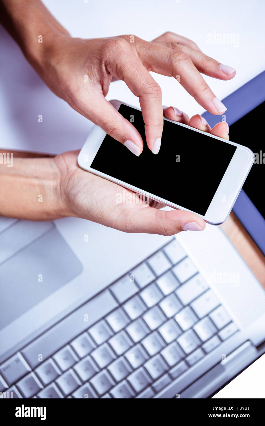 Businesswoman using her smartphone on desk Stock Photo - Alamy