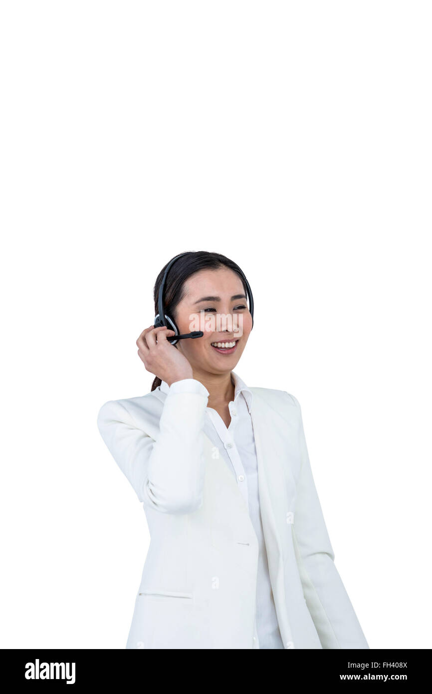 Smiling businesswoman using headset Stock Photo - Alamy
