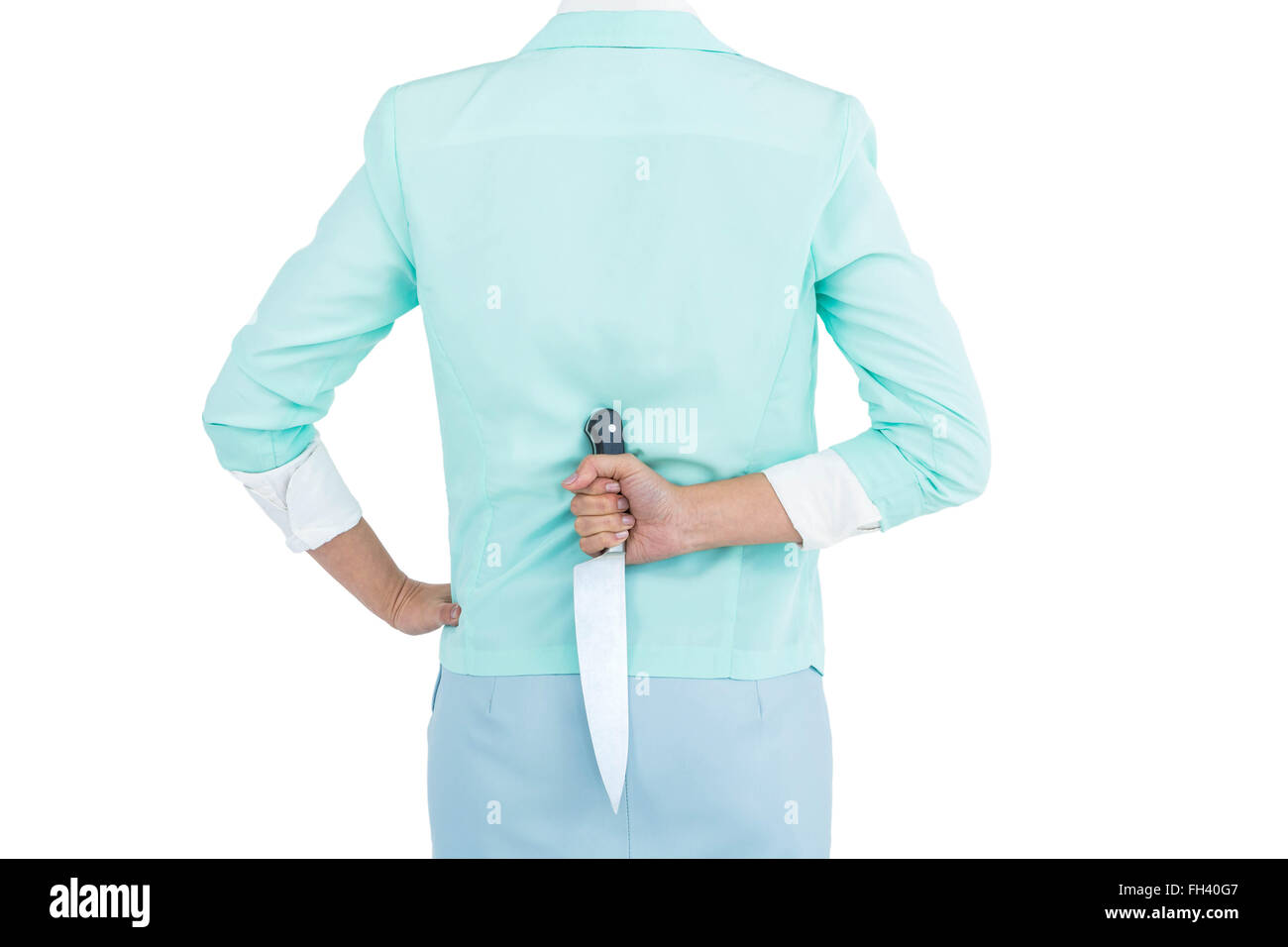 Rear view of businesswoman hiding knife in her back Stock Photo - Alamy