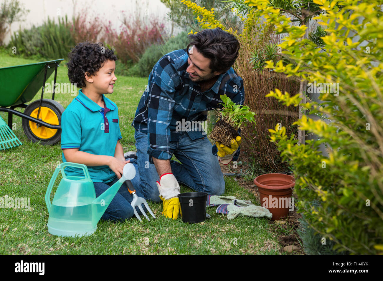 Smiling father and son gardening Stock Photo - Alamy