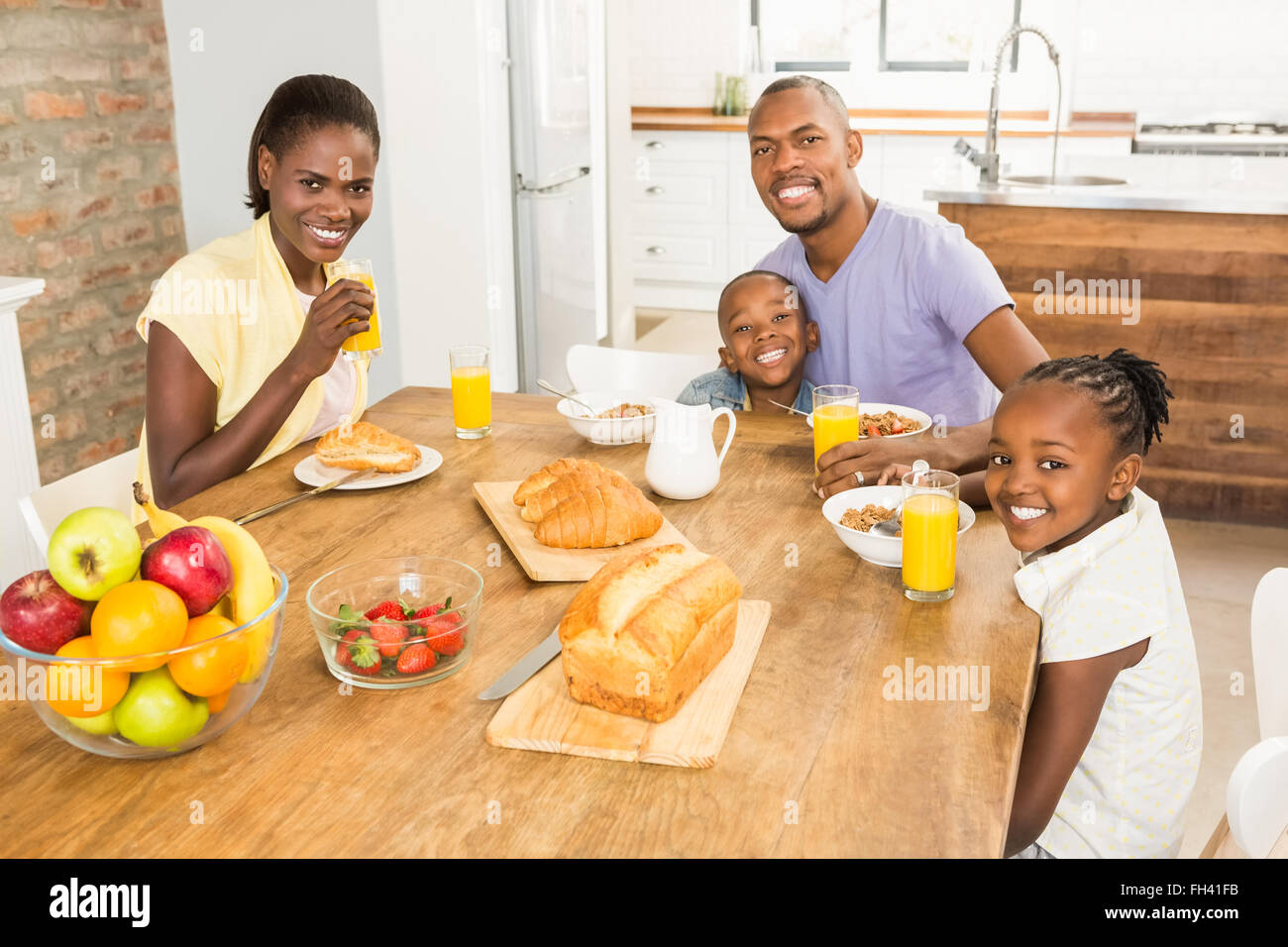 Casual happy family having breakfast Stock Photo - Alamy