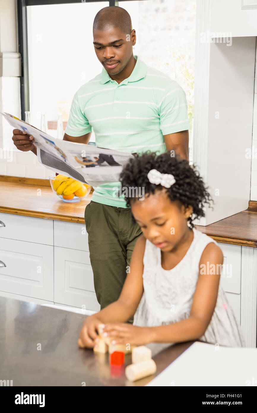 Concentrated father reading newspaper Stock Photo - Alamy