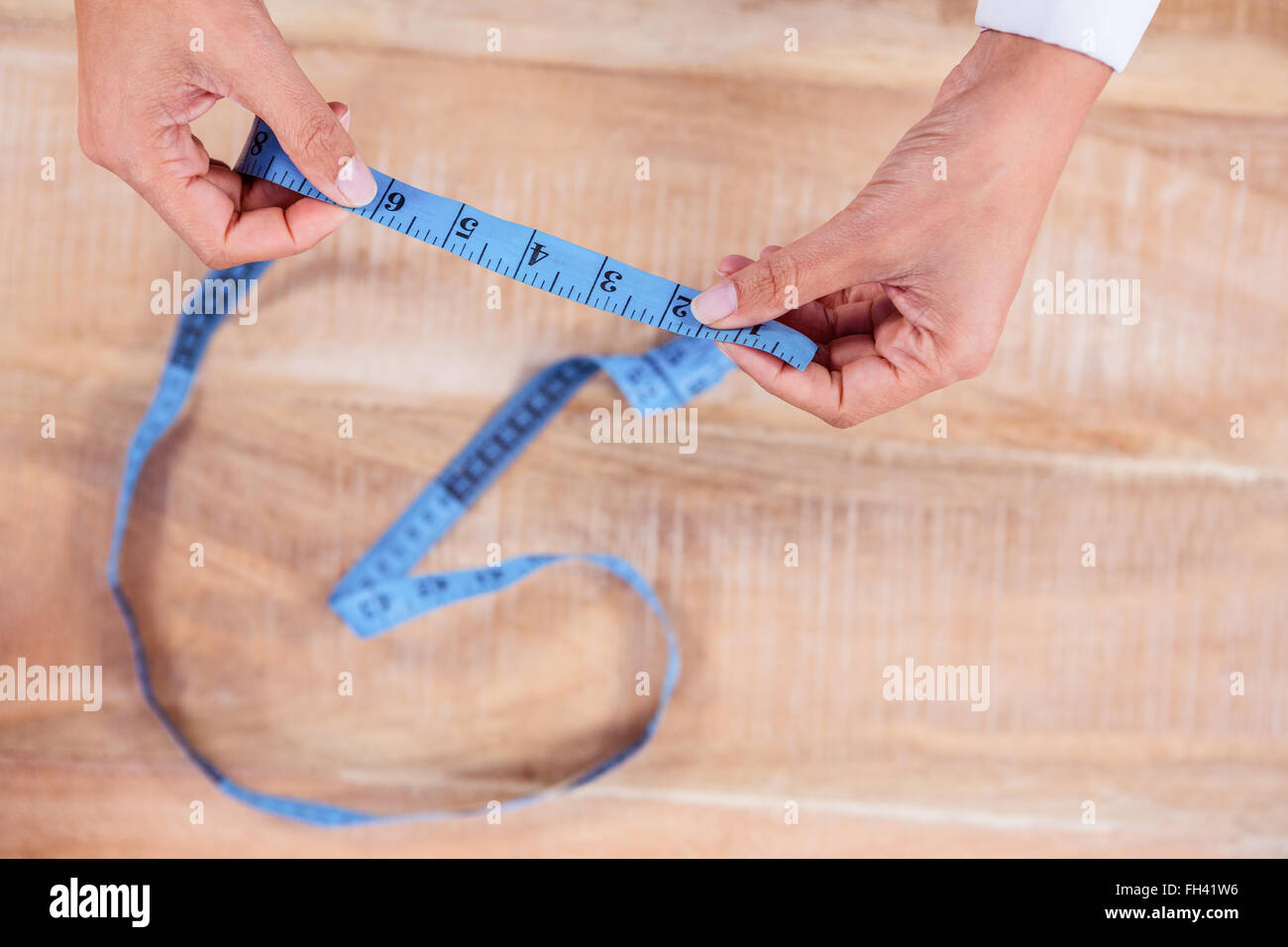 Woman holding measuring tape Stock Photo - Alamy