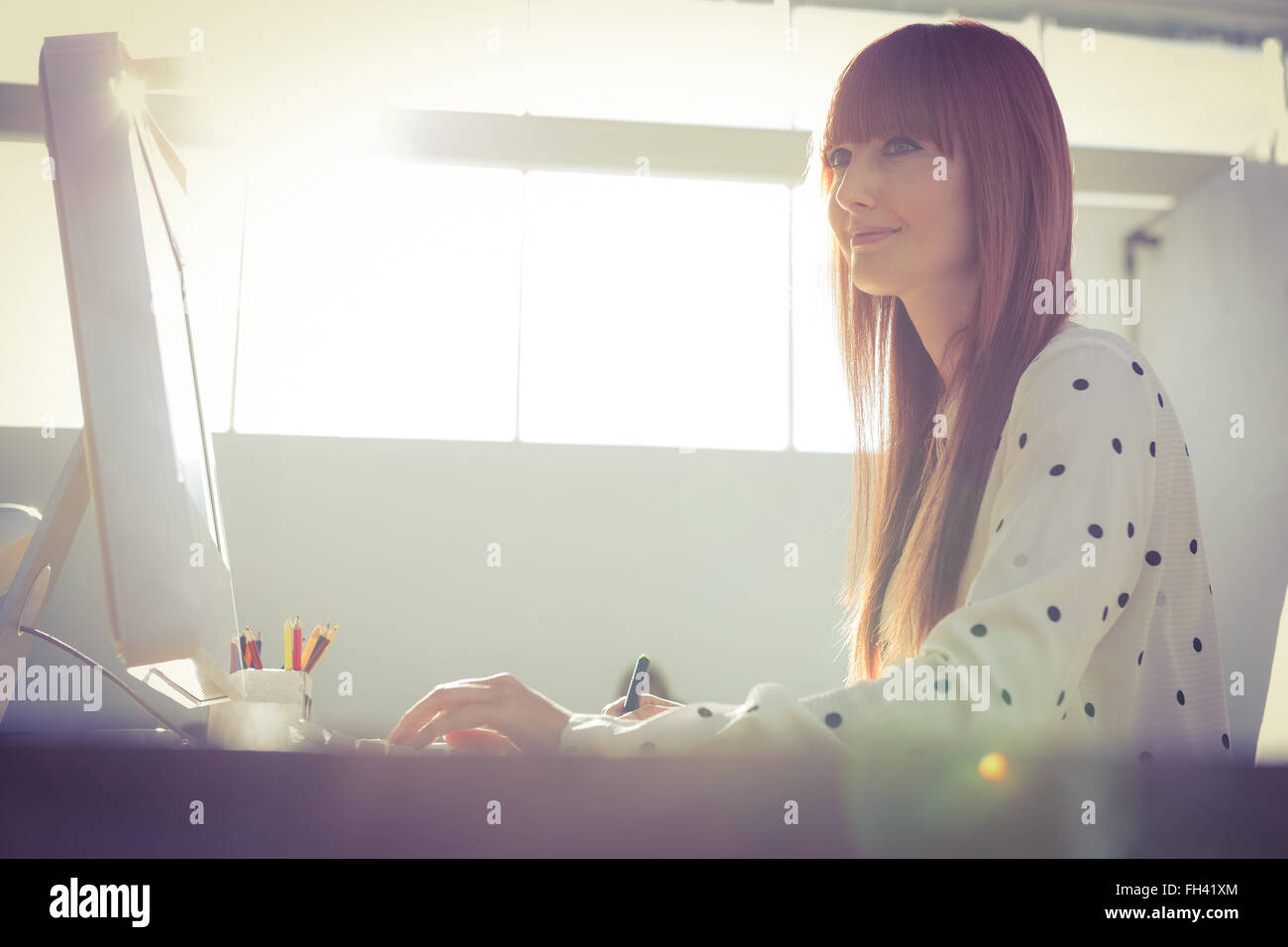 Smiling woman using graphics tablet Stock Photo - Alamy