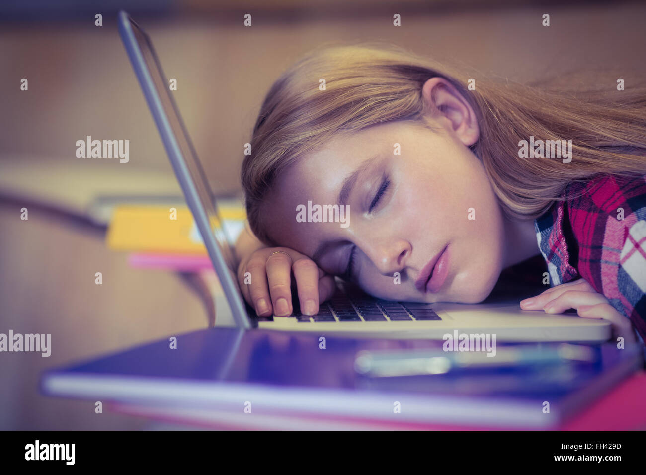 Blonde student sleeping on laptop Stock Photo - Alamy