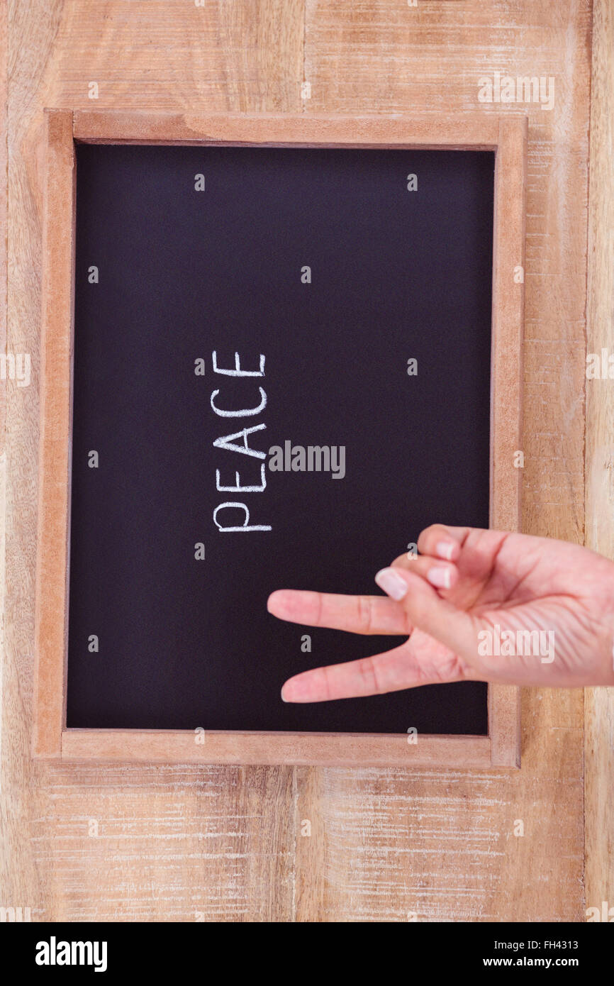 View of hands making peace sign Stock Photo - Alamy