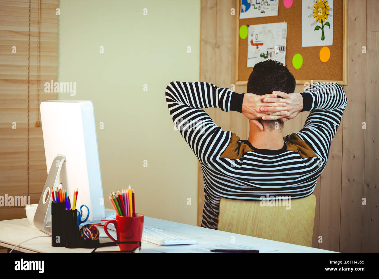 Man relaxing at his desk Stock Photo - Alamy