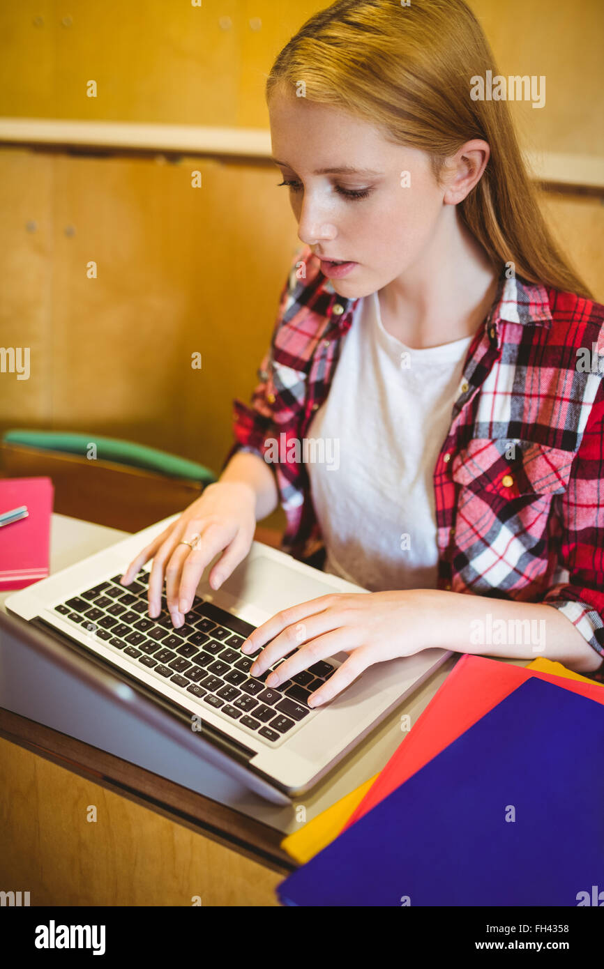 Focused student using laptop during class Stock Photo - Alamy