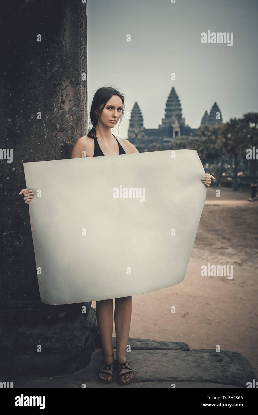 Young woman holding paper Stock Photo - Alamy