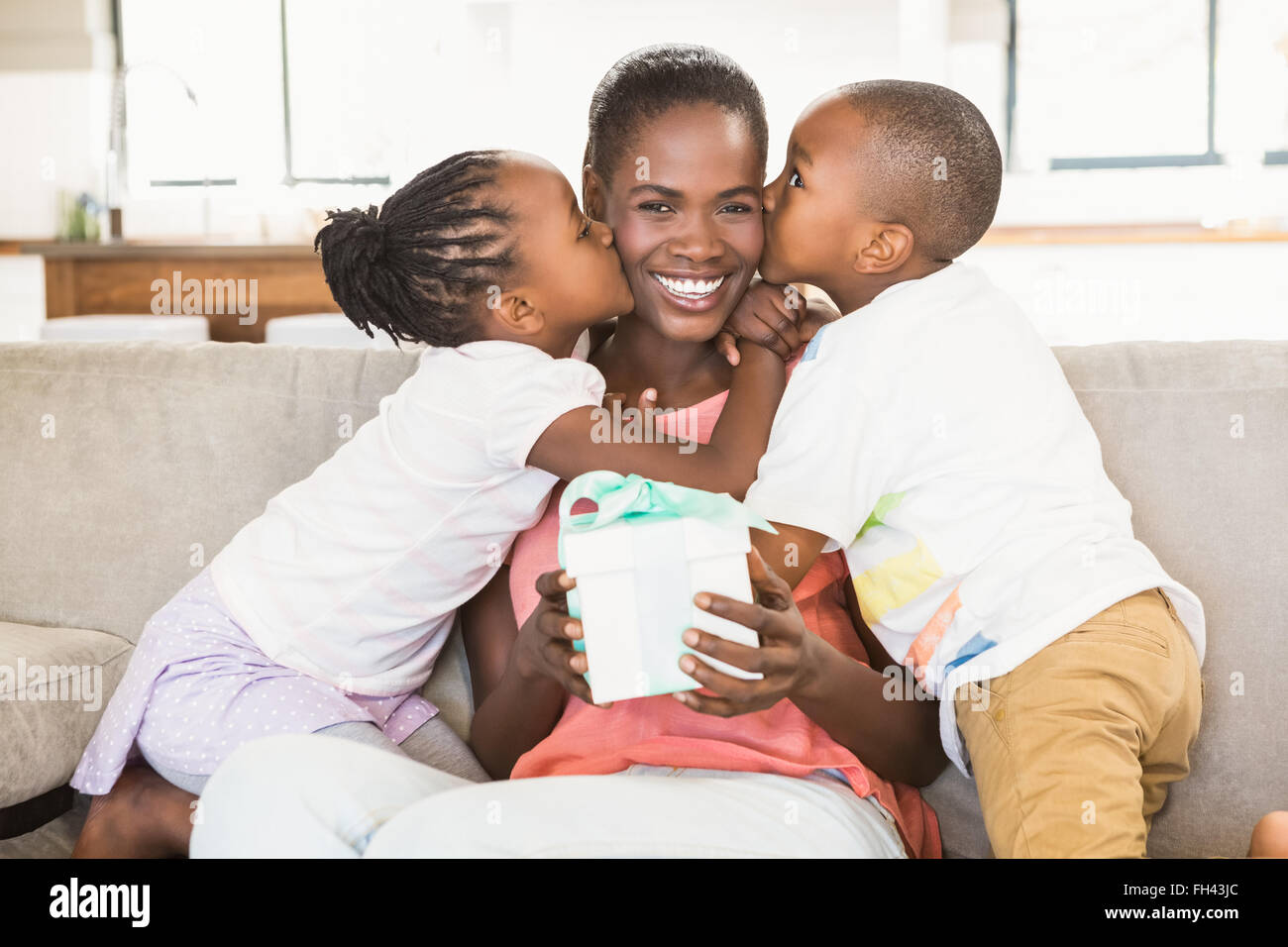 Children offering a gift to their mother Stock Photo - Alamy