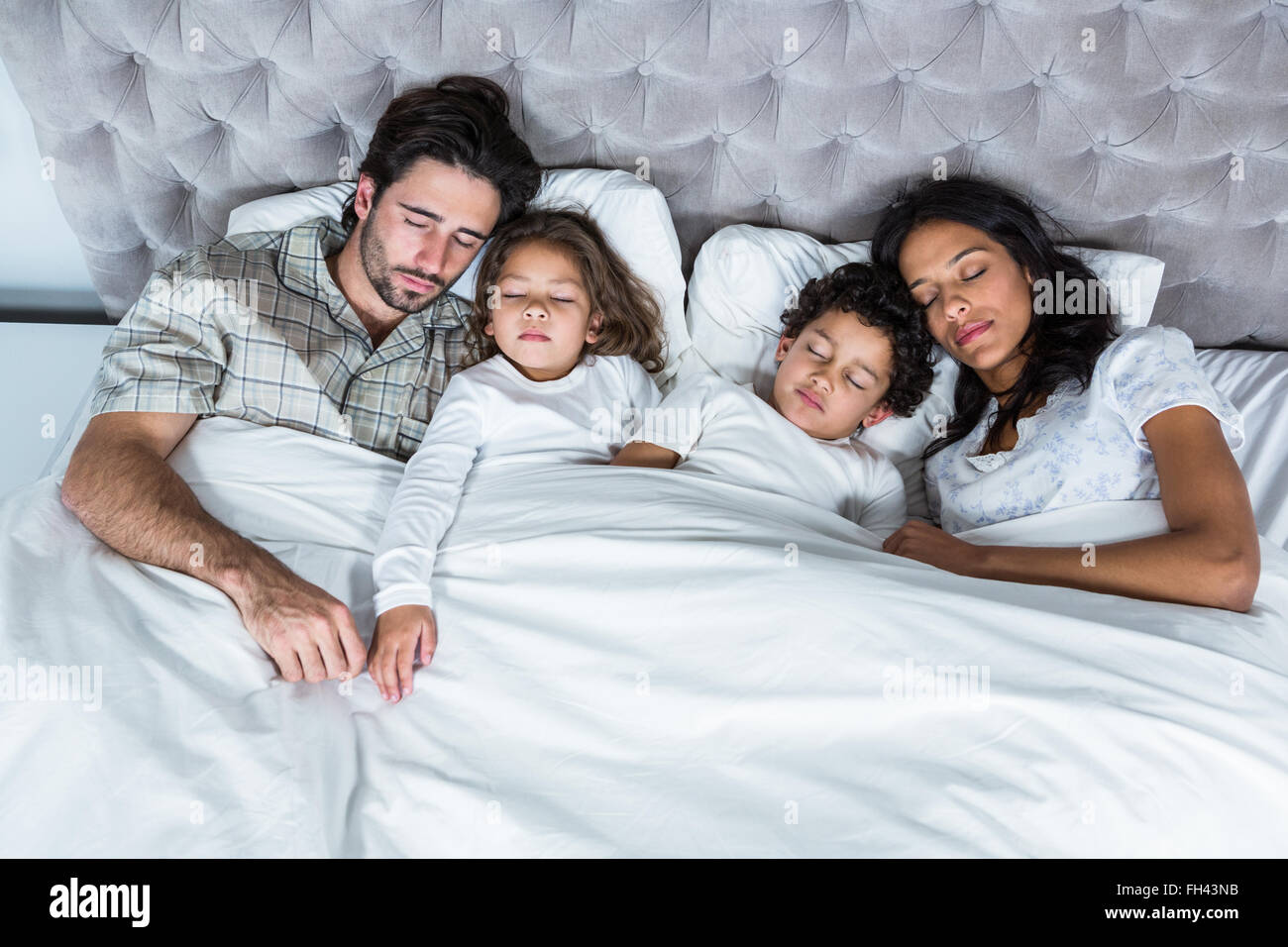 Family sleeping together Stock Photo - Alamy