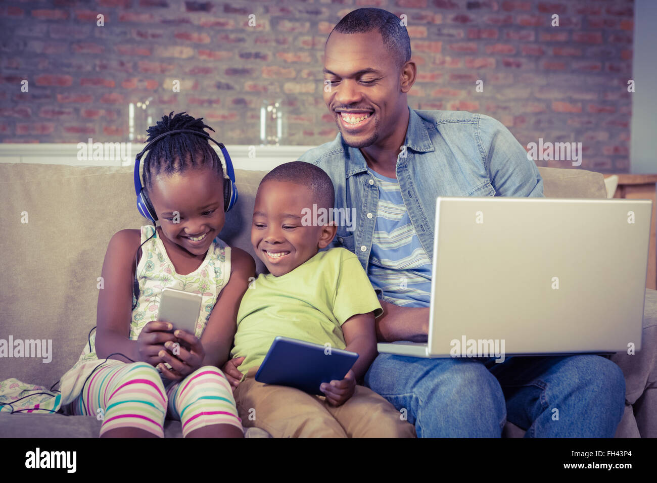 Happy family using technology together Stock Photo - Alamy
