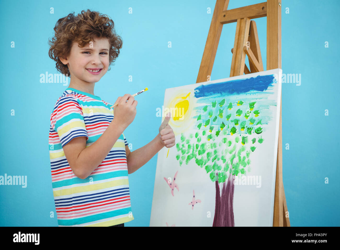 Happy boy painting his picture Stock Photo - Alamy