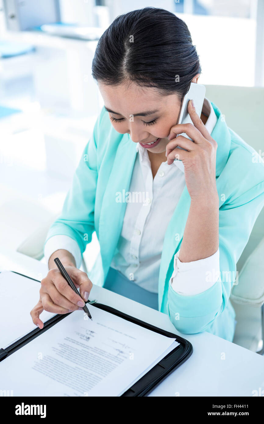 Smiling businesswoman taking notes Stock Photo - Alamy