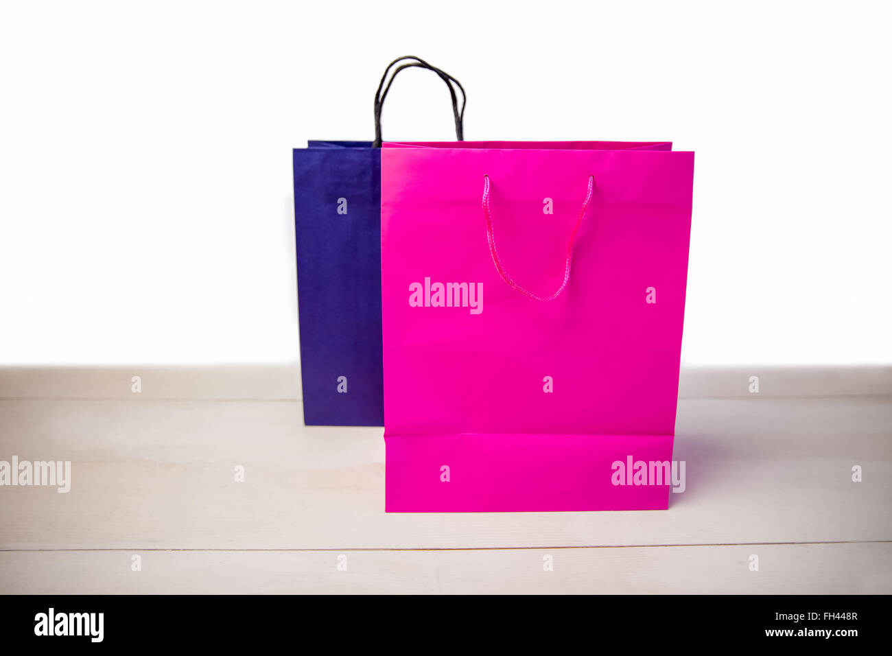 Shopping gift bags on desk Stock Photo - Alamy